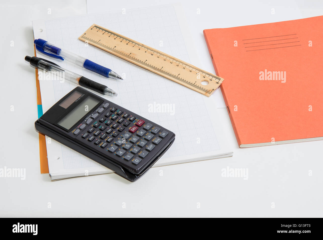 The concept of learning shown with a calculator & pens on a background ...