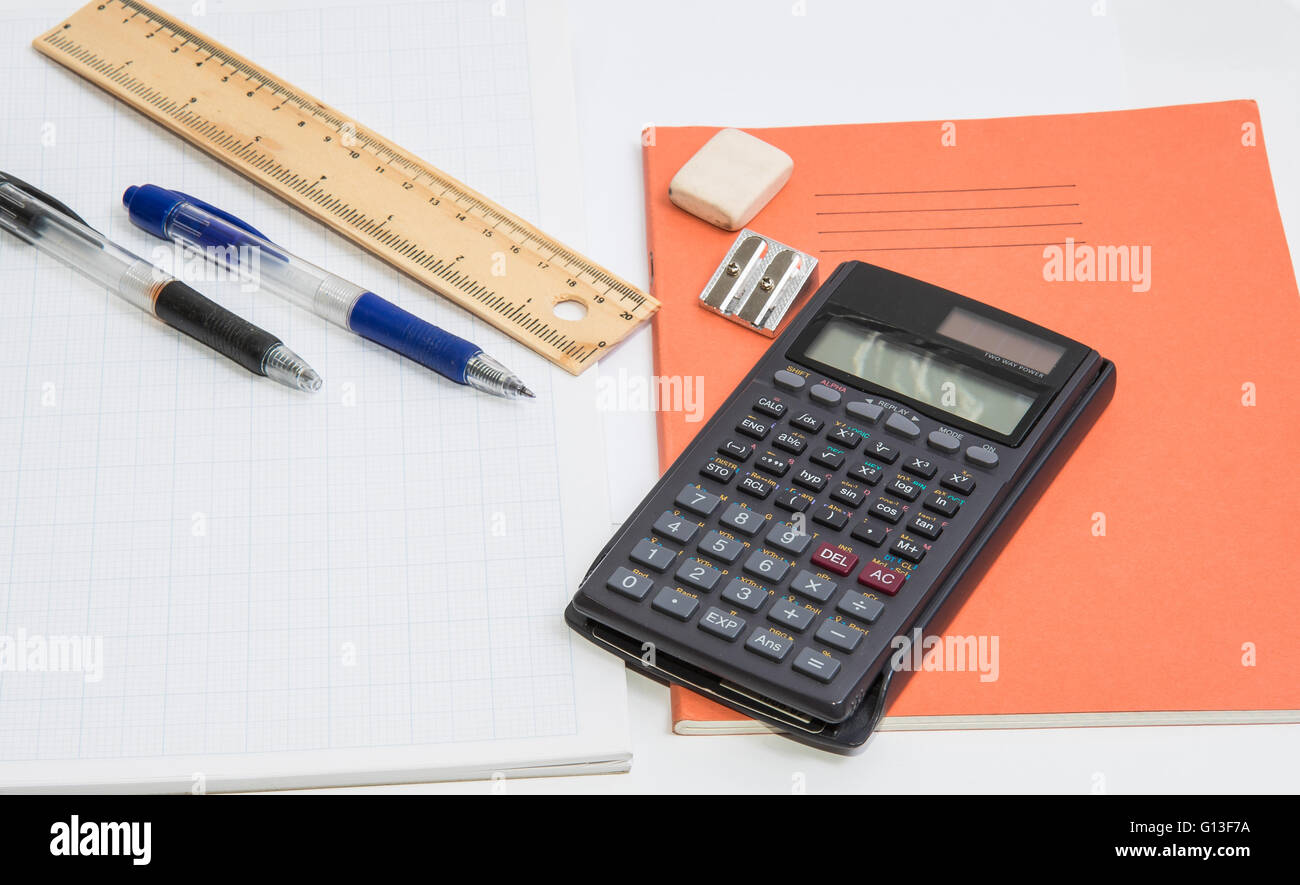 The concept of learning shown with a calculator & pens on a background ...