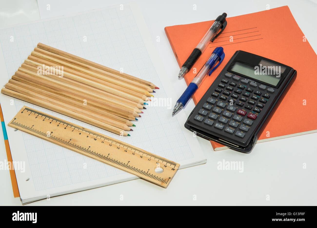 The concept of learning shown with a calculator & pens on a background ...
