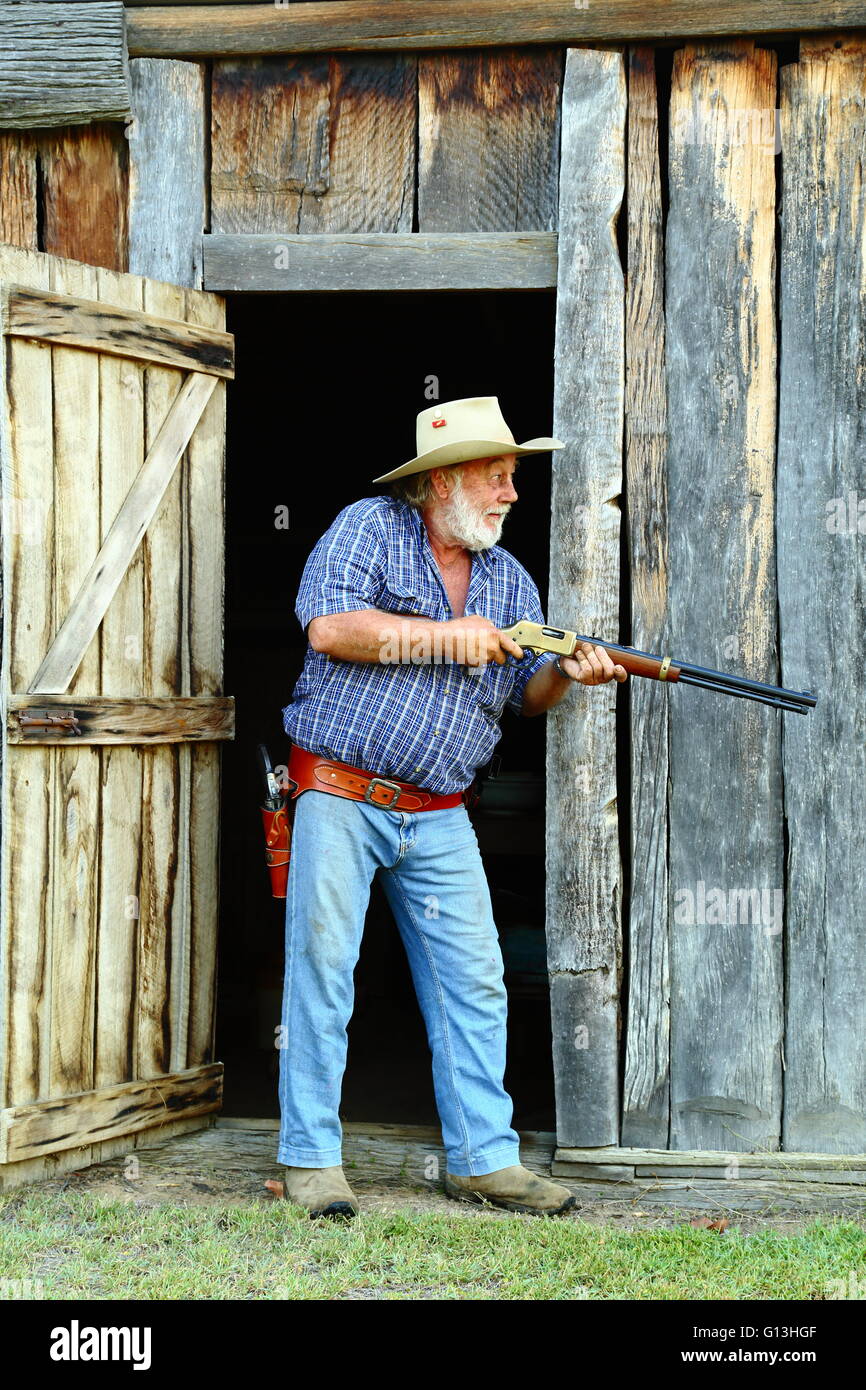 Cowboy with rifle hi-res stock photography and images - Alamy