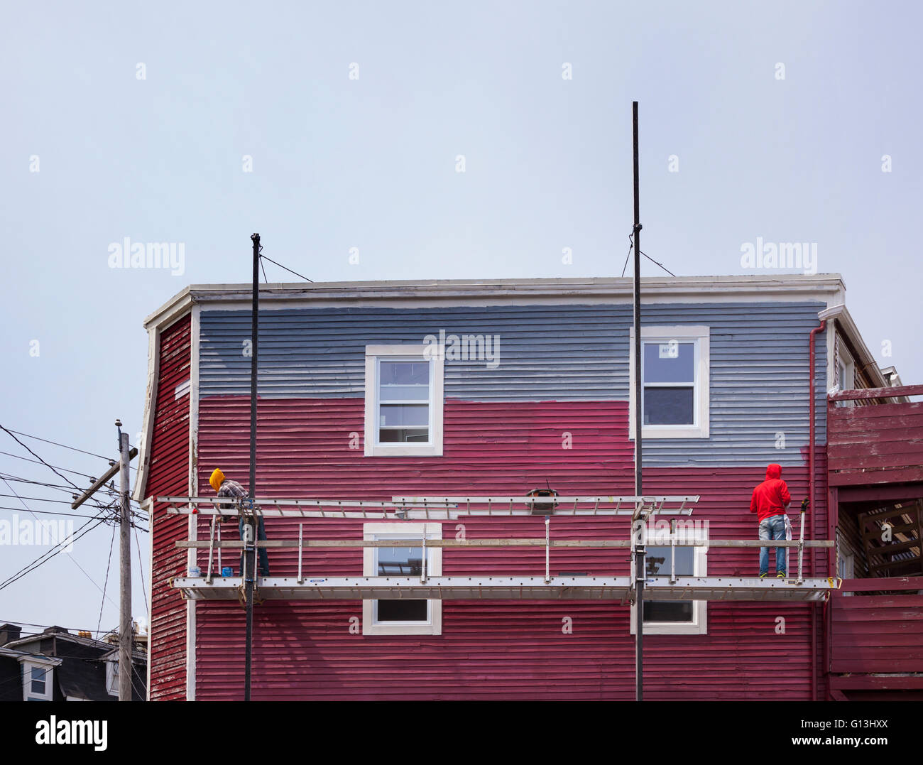 Painters paiting a corner row house (Jellybean Row) in downtown St ...