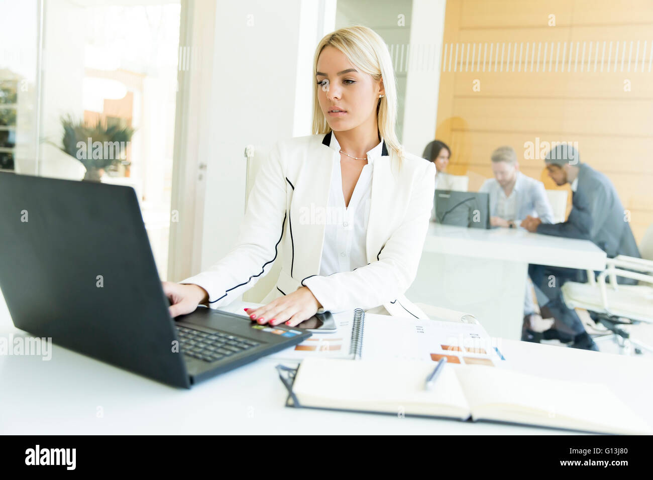 Pretty young blond woman working in the mdoern office Stock Photo - Alamy