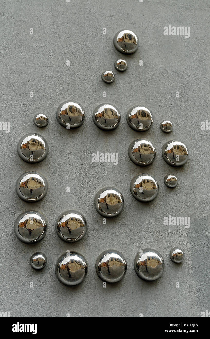 Metal spheres on the wall with reflection of the Cathedral of Leon ...
