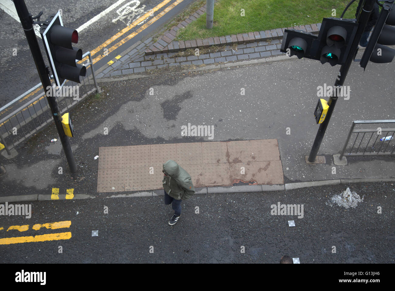 young Asian person crossing street at traffic lights shot graphically ...