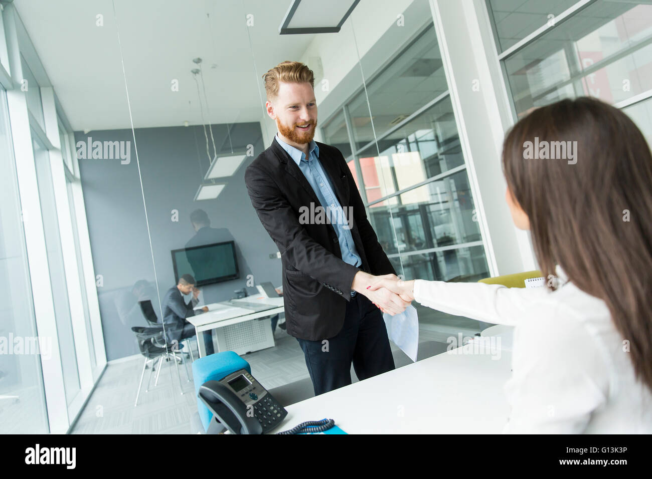 Business people shaking hands in the office Stock Photo - Alamy