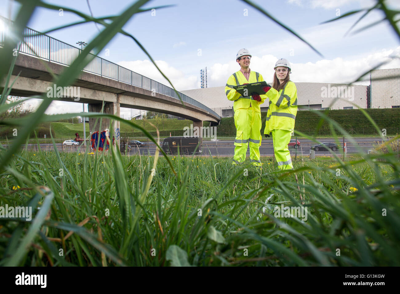 Young man and woman surveyors wearing Hi Viz on location Stock Photo ...