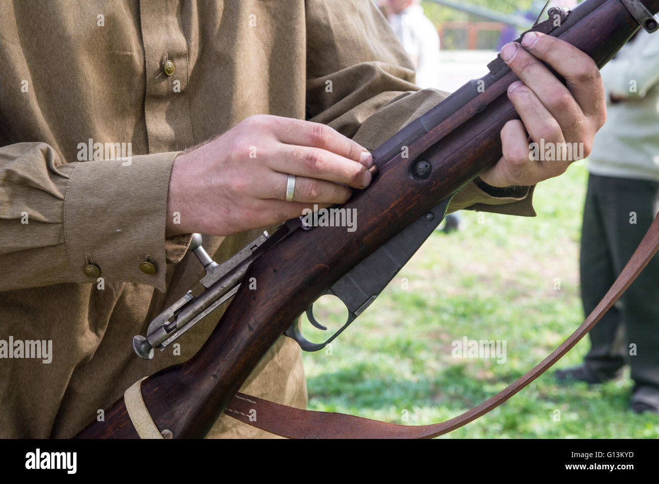 Man charges the old rifle Stock Photo - Alamy