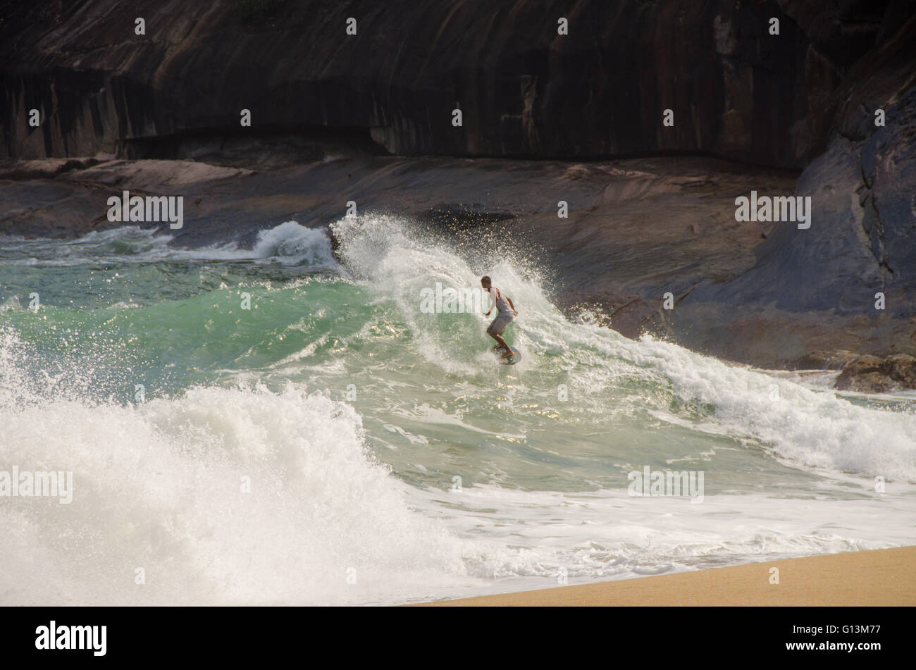 Surfer riding a wave Stock Photo - Alamy