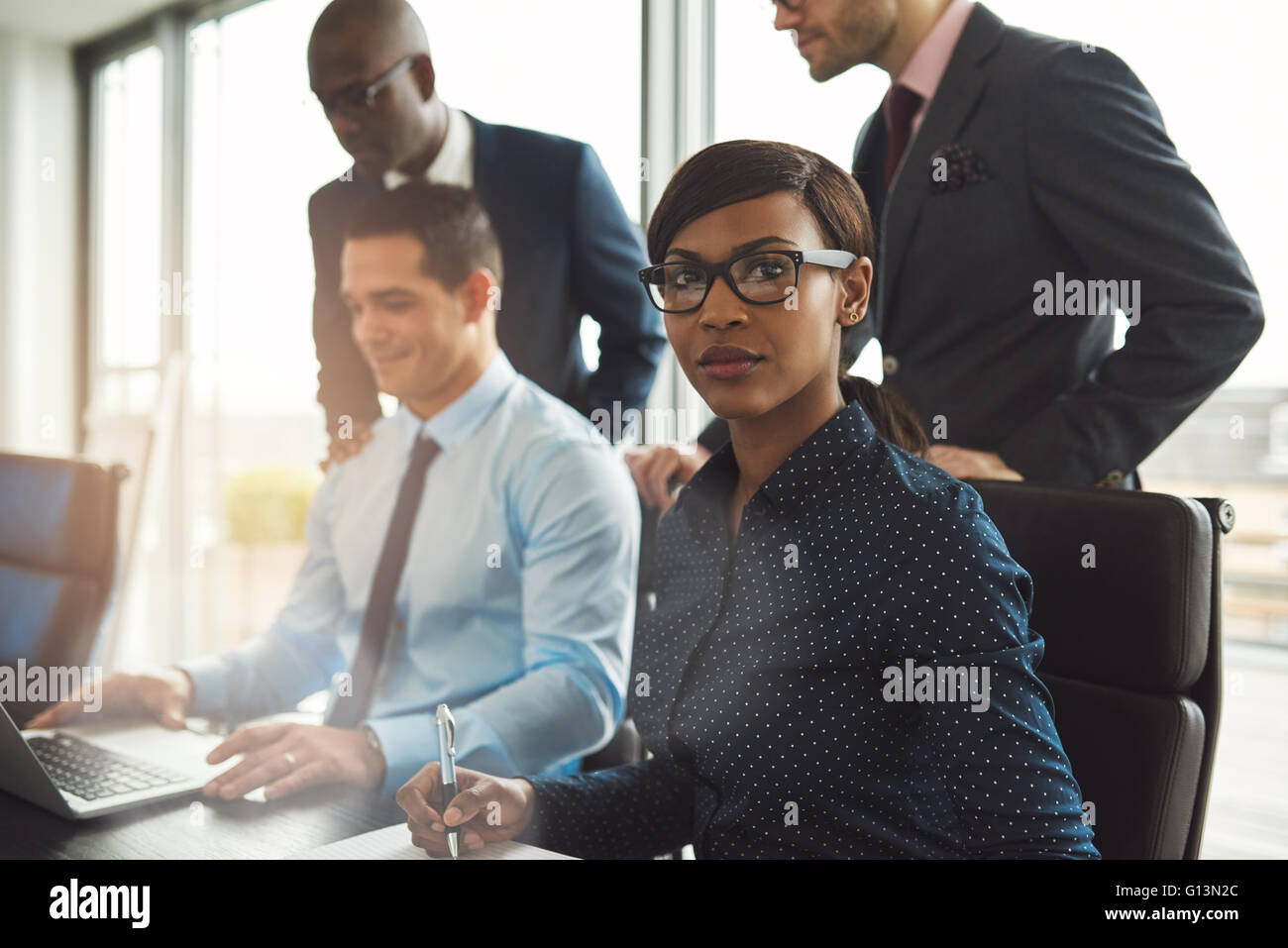 Attractive serious businesswoman wearing eyeglasses and blue blouse ...