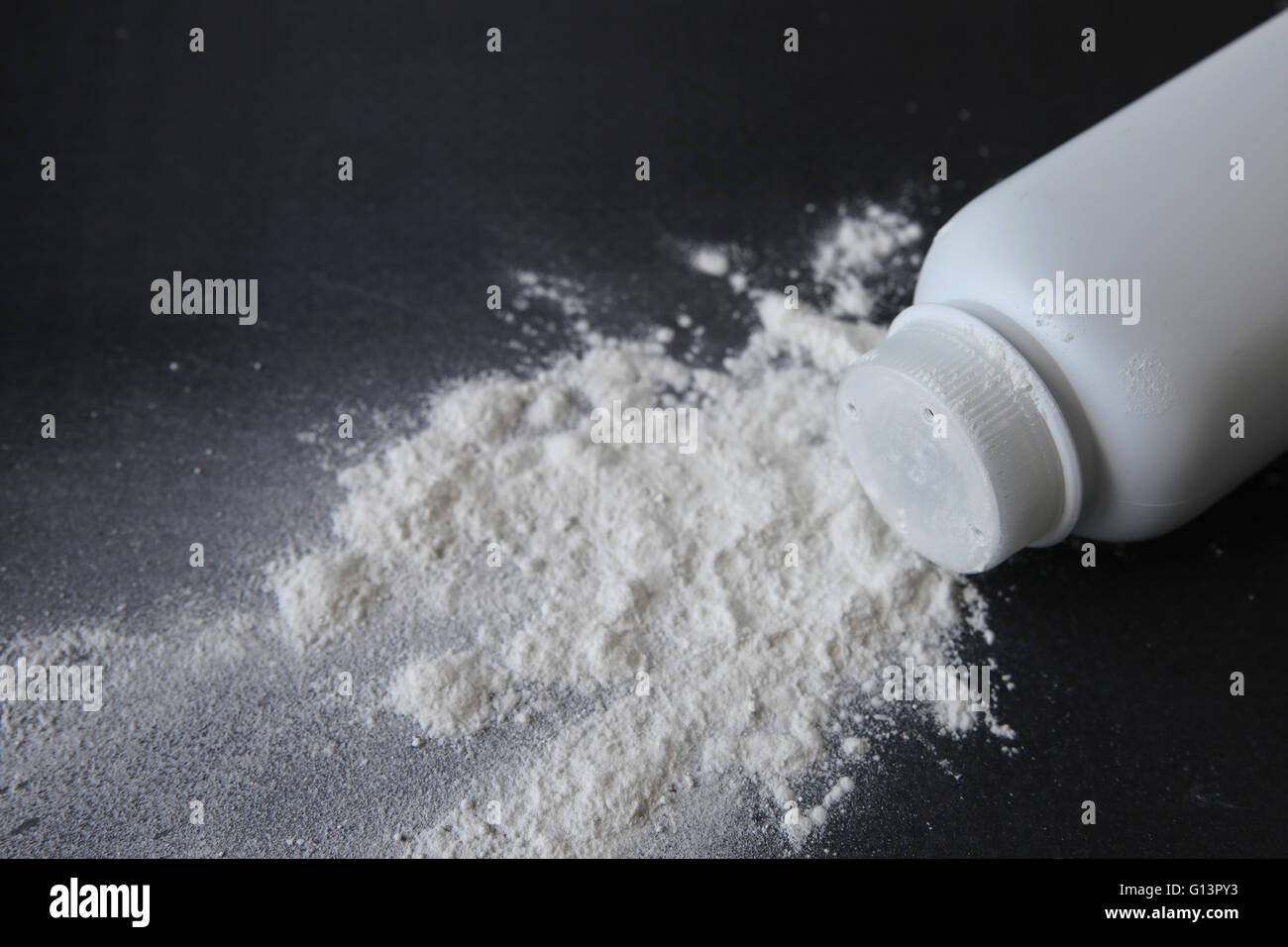 Talcum powder on black background Stock Photo - Alamy