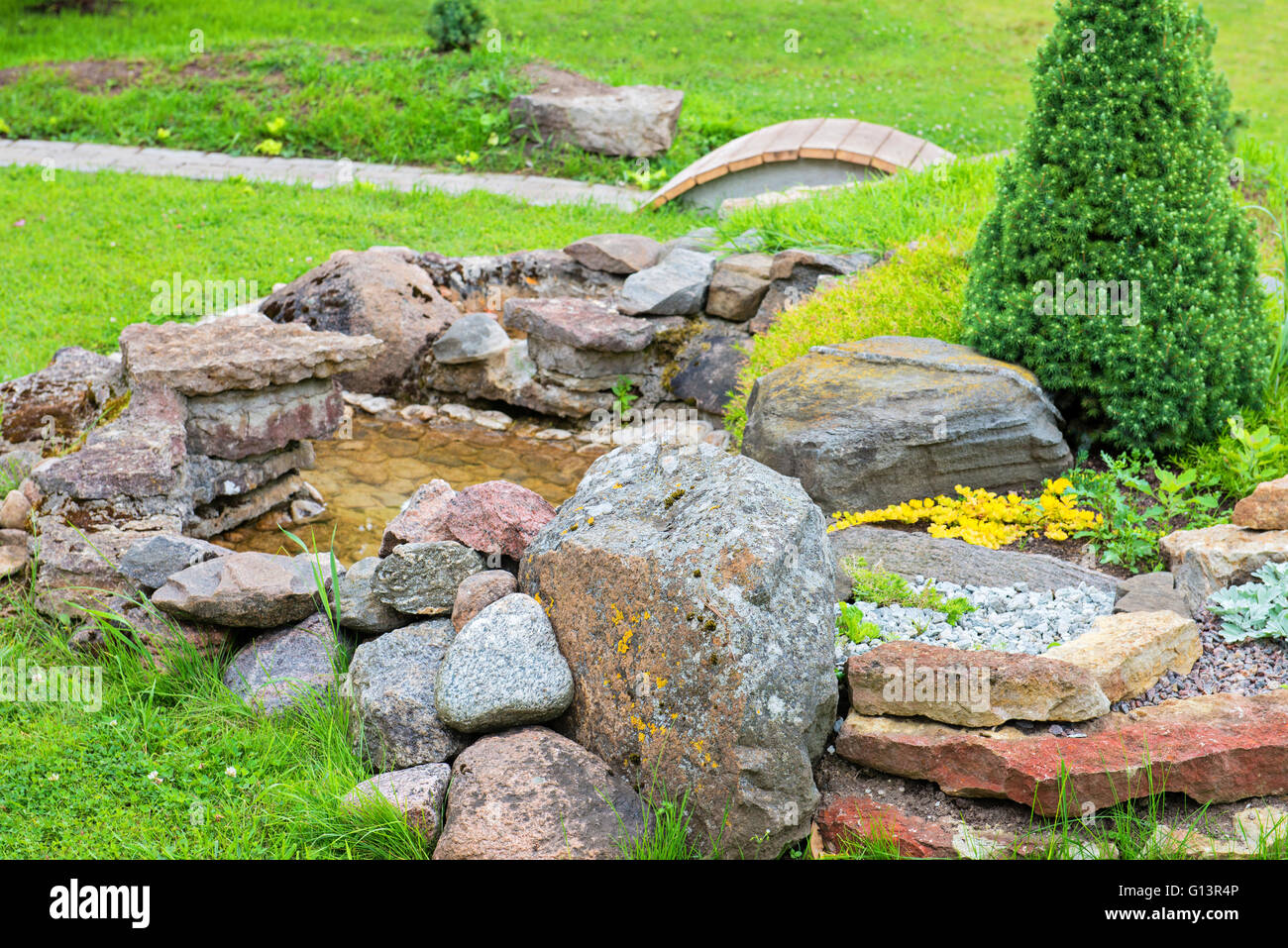 Alpine garden with green grass Stock Photo - Alamy