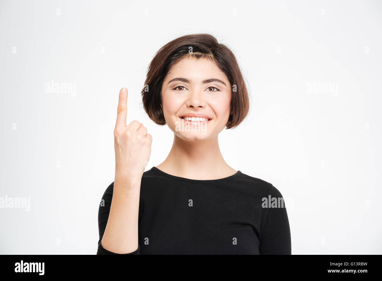 Smiling woman showing one finger isolated on a white background Stock ...
