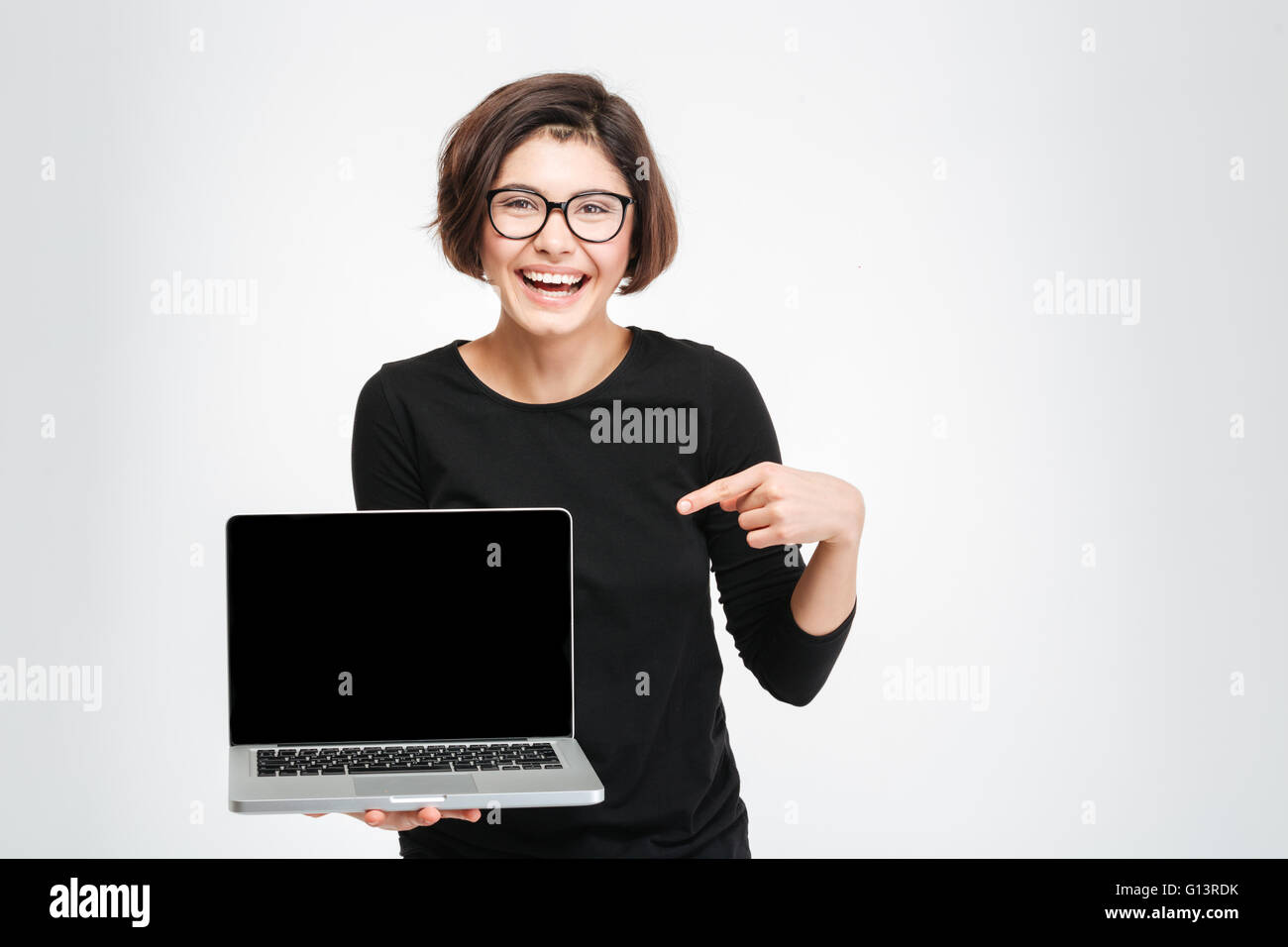 Laughing woman pointing finger on blank laptop computer screen isolated ...