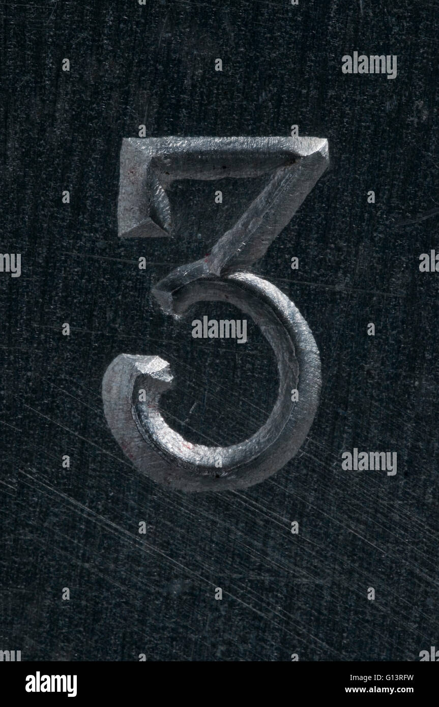 Macro view of a single letter "3" stamped in black metal Stock Photo ...