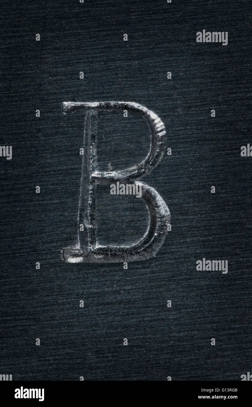 Macro view of a single letter "B" stamped in black metal Stock Photo ...