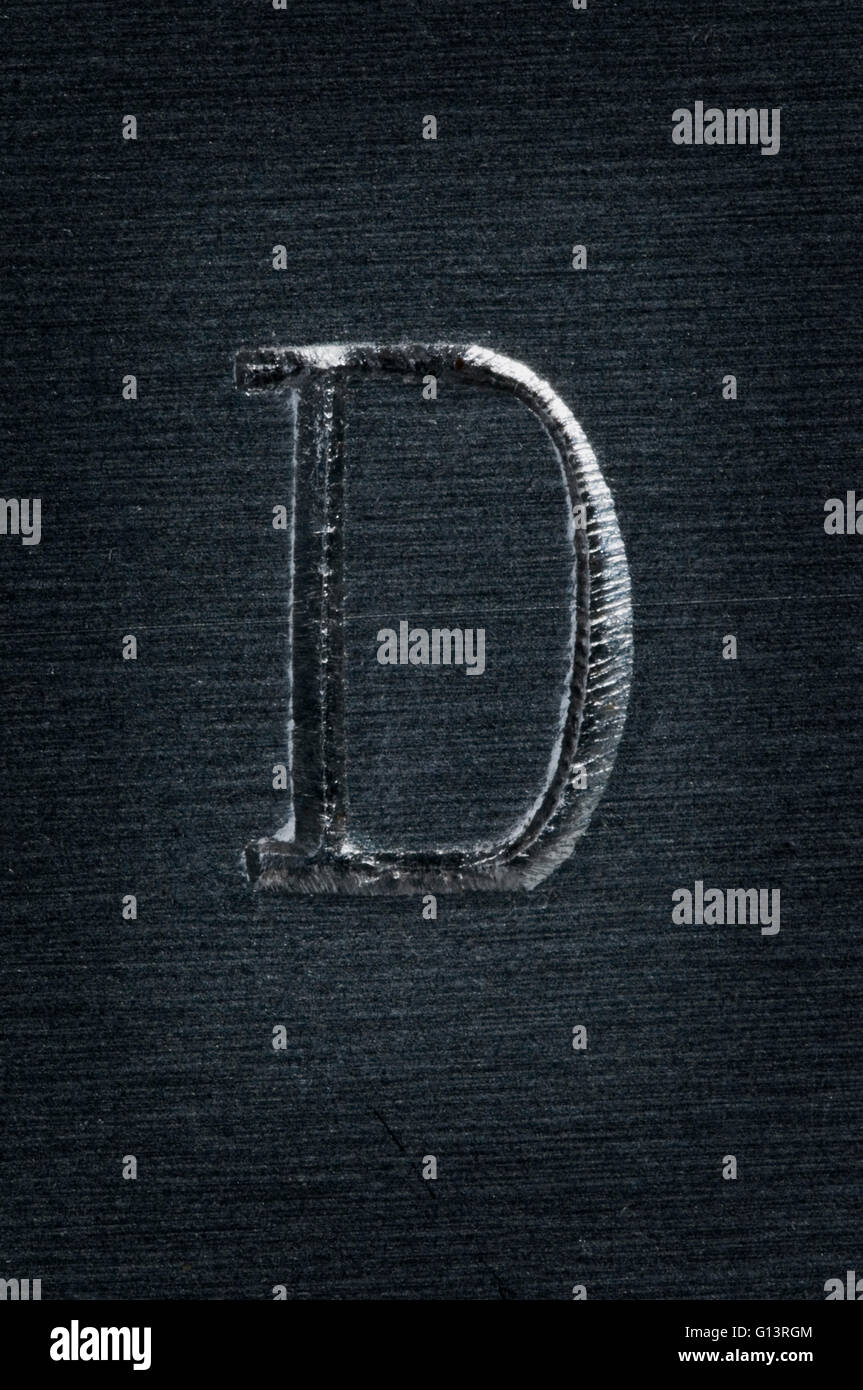 Macro view of a single letter "D" stamped in black metal Stock Photo ...