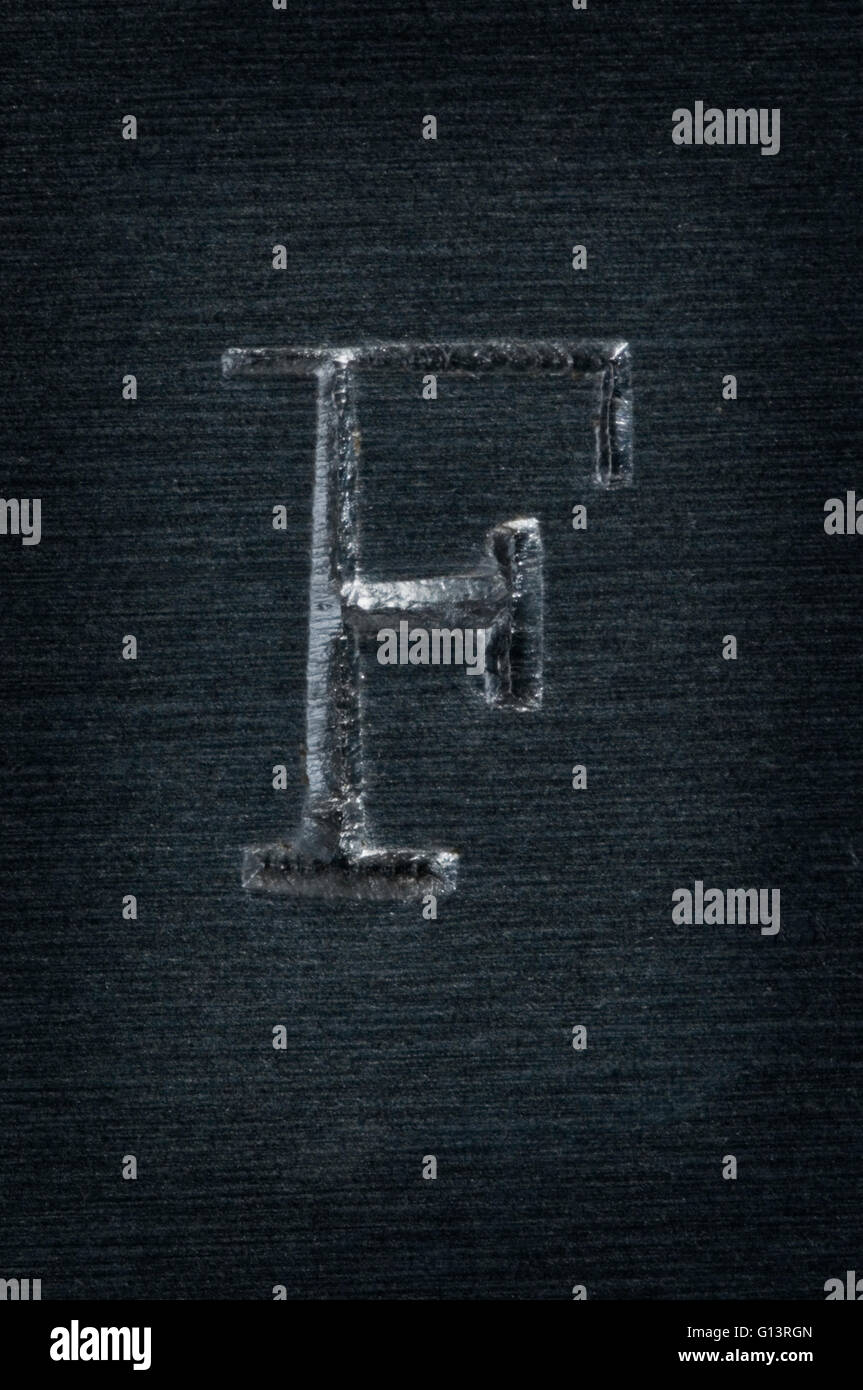 Macro view of a single letter "F" stamped in black metal Stock Photo ...