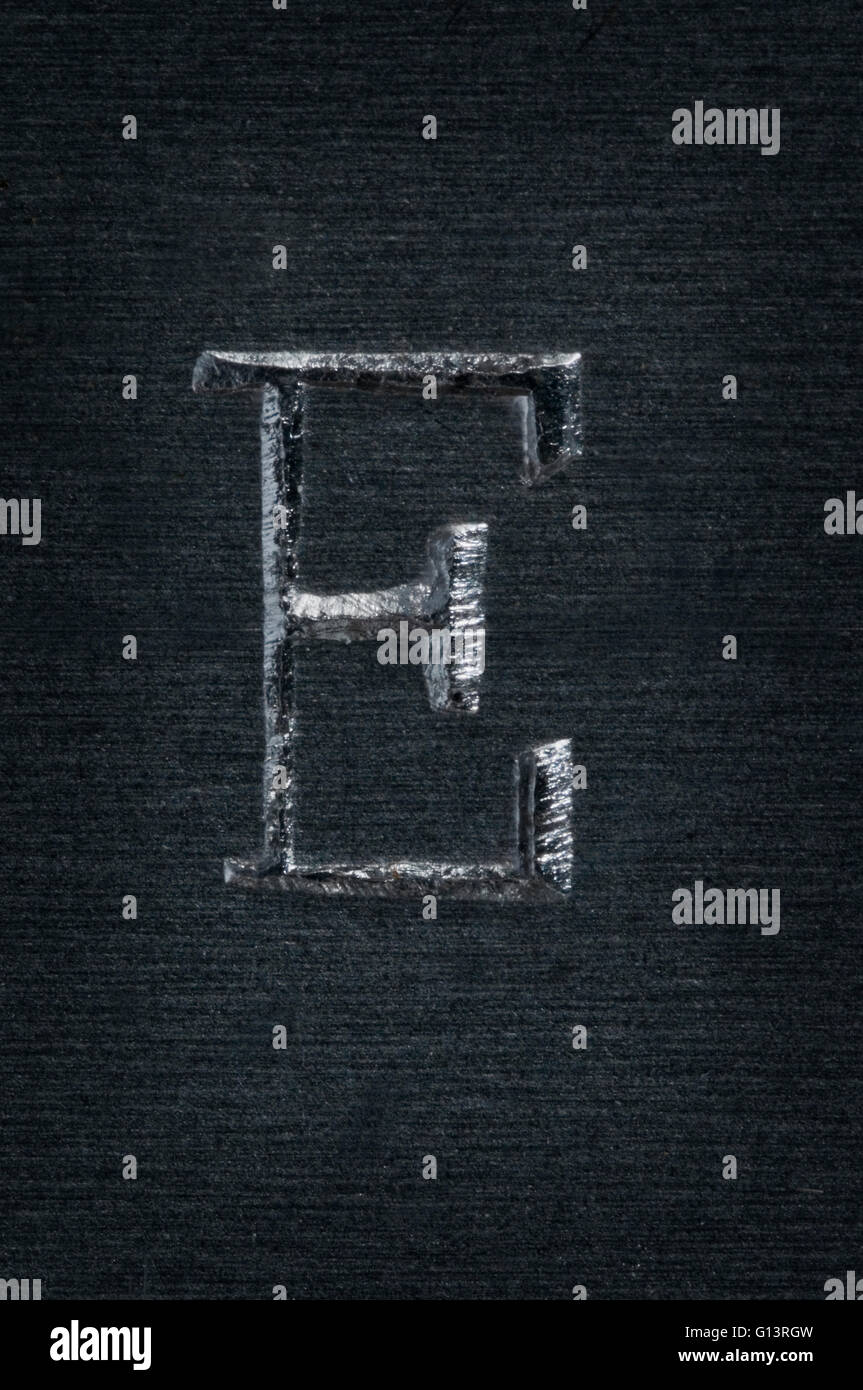 Macro view of a single letter "E" stamped in black metal Stock Photo ...