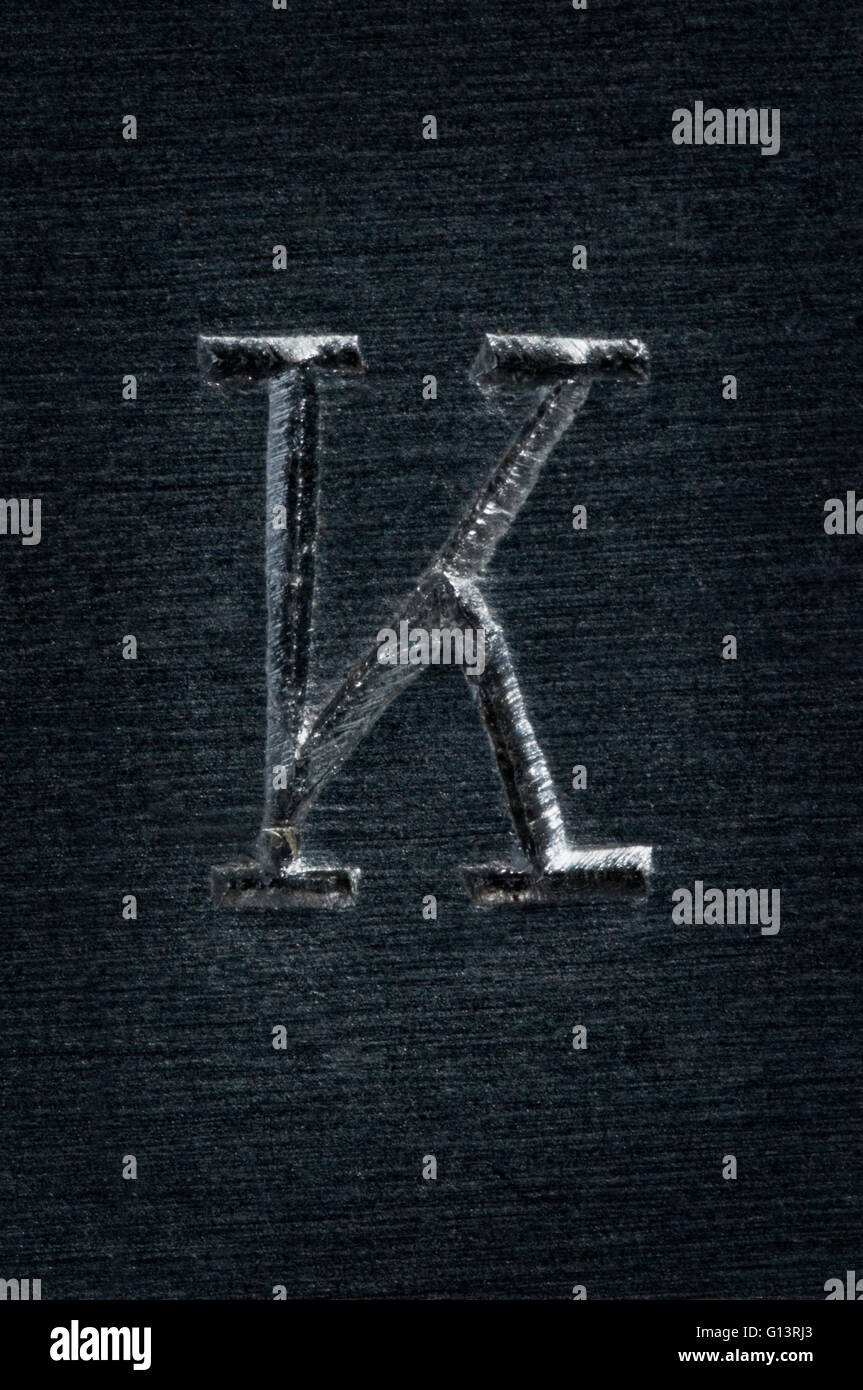 Macro view of a single letter "K" stamped in black metal Stock Photo ...
