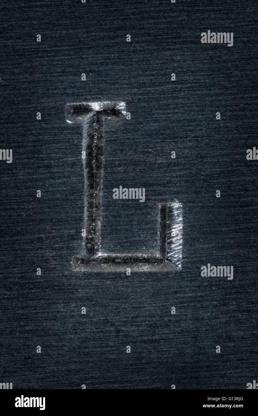 Macro view of a single letter "L" stamped in black metal Stock Photo ...
