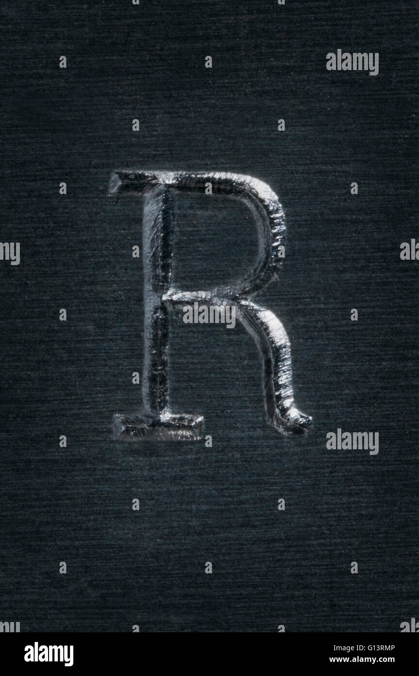 Macro view of a single letter "R" stamped in black metal Stock Photo ...