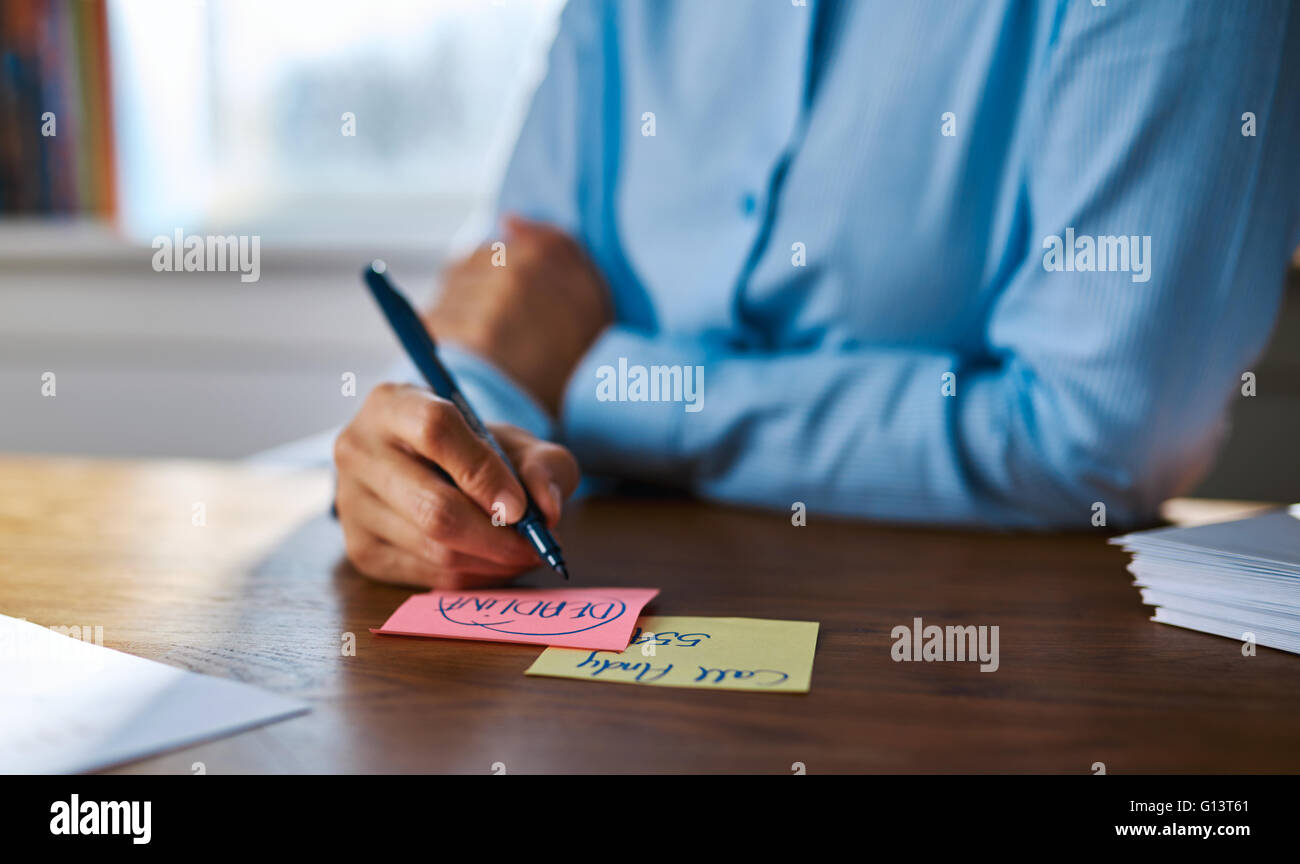 Creative young woman drawing designs in the office on colorful memo ...