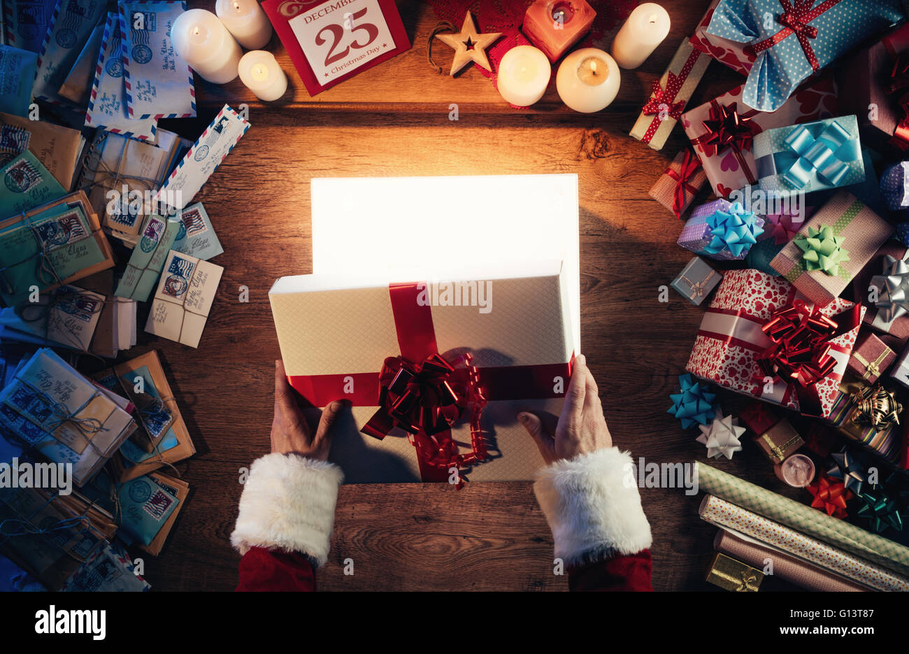 Santa claus opening a magic bright christmas gift box hi-res stock ...
