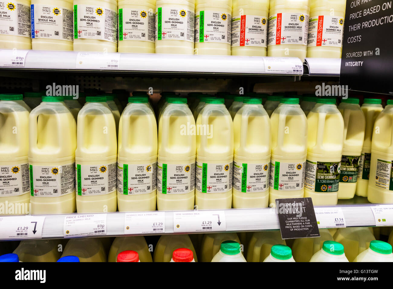 milk bottles on shelf in supermarket display skimmed full fat milks ...