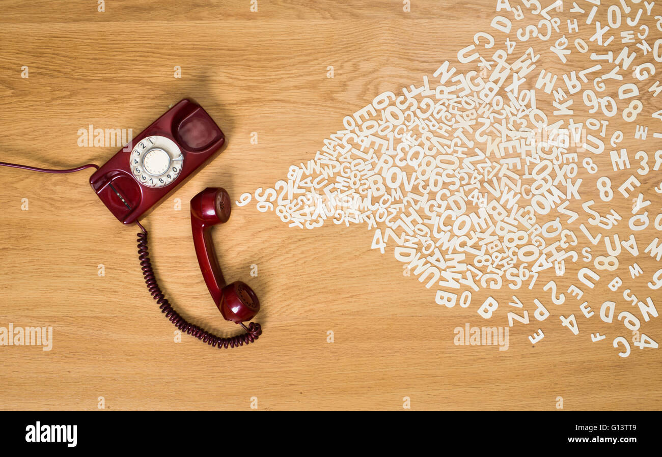 Phone call concept with plastic letters coming out from receiver on the ...