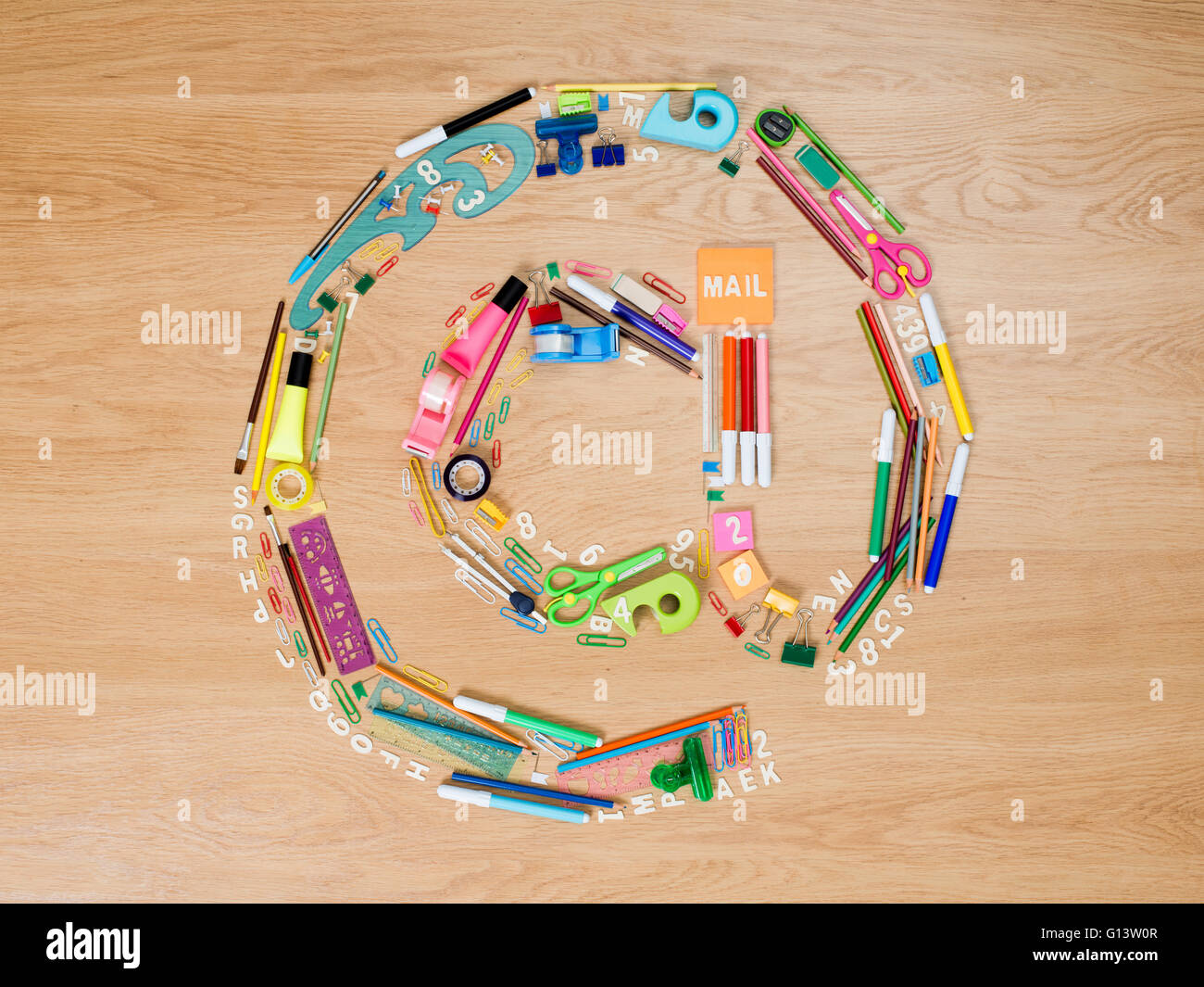 Creative e-mail symbol on the floor composed of stationery objects ...