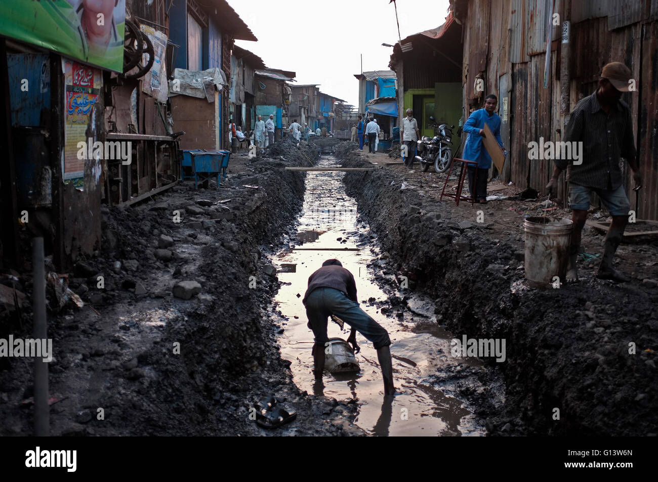 a clean up process a side street in a slum area of the kurla district ...