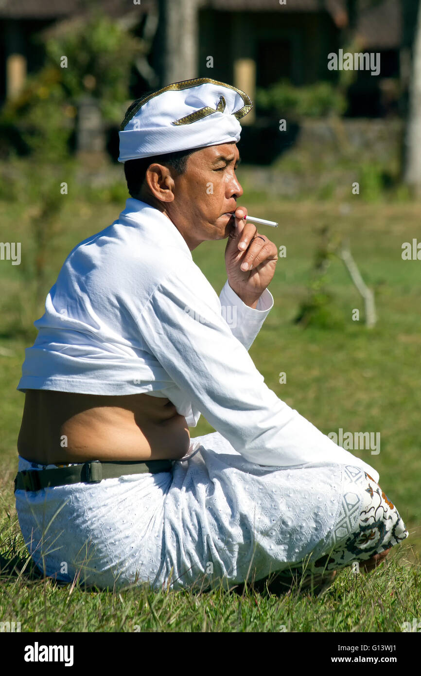 A Balinese man smoking a cigarette at Lake Batur Stock Photo - Alamy