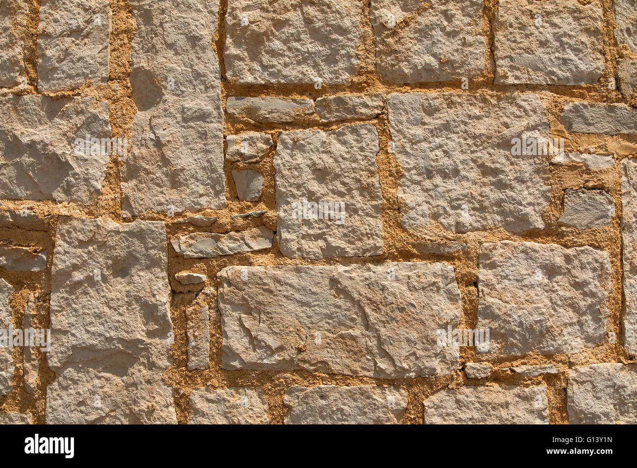 Closeup on rock wall with yellow mortar Stock Photo - Alamy