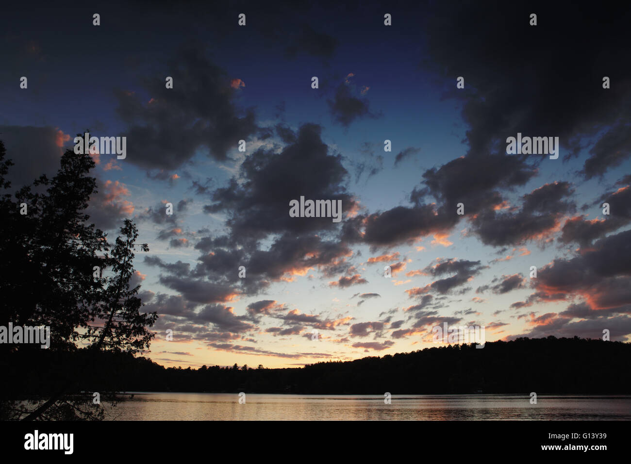 Landscape sunset over a lake in Western Vermont with purple clouds ...