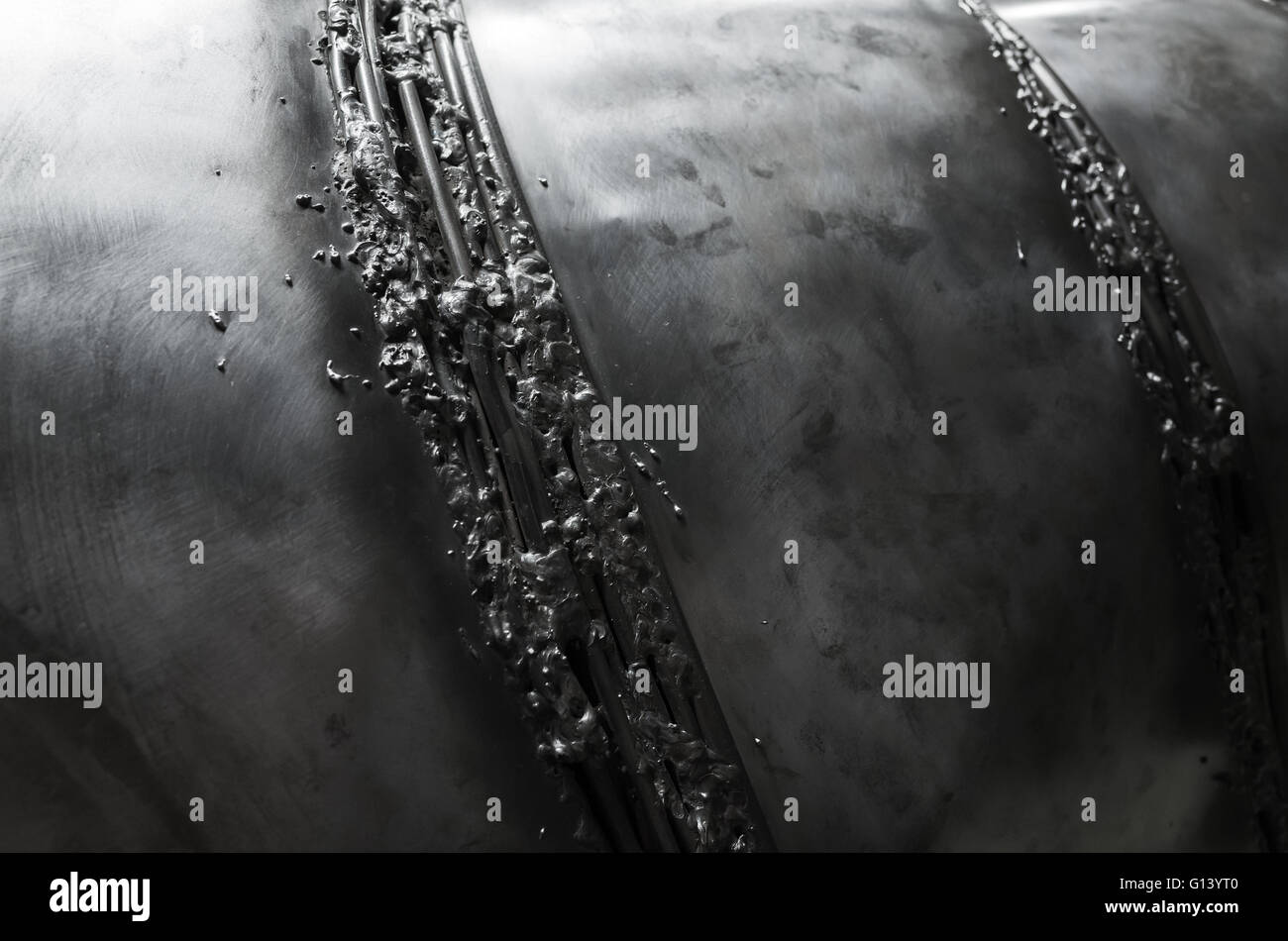 Black shining metal surface with weld seam elements, closeup photo with ...