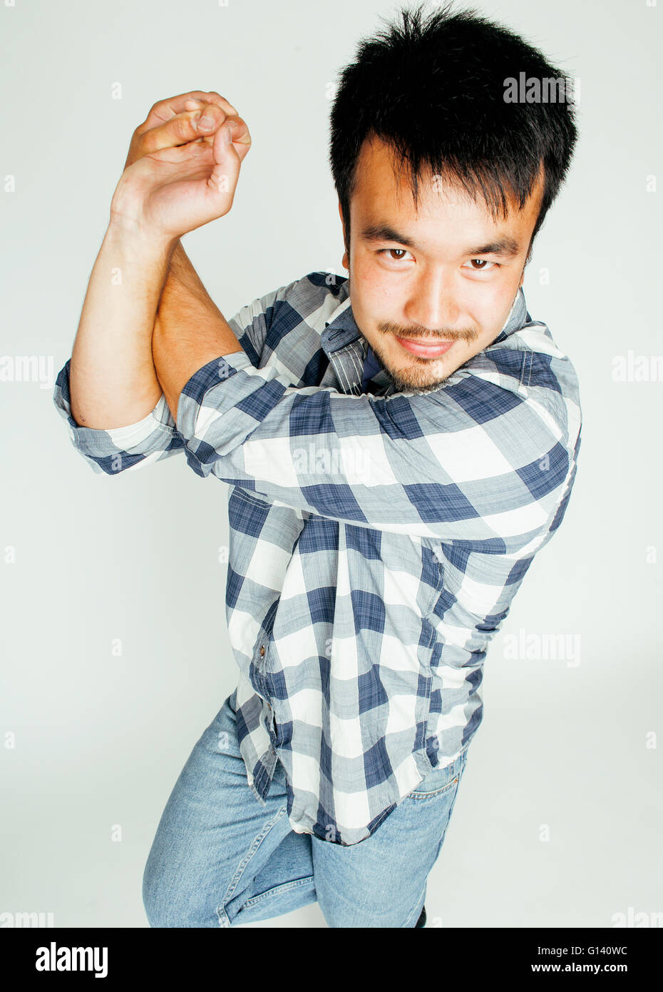 young cute asian man on white background gesturing emotional, pointing ...