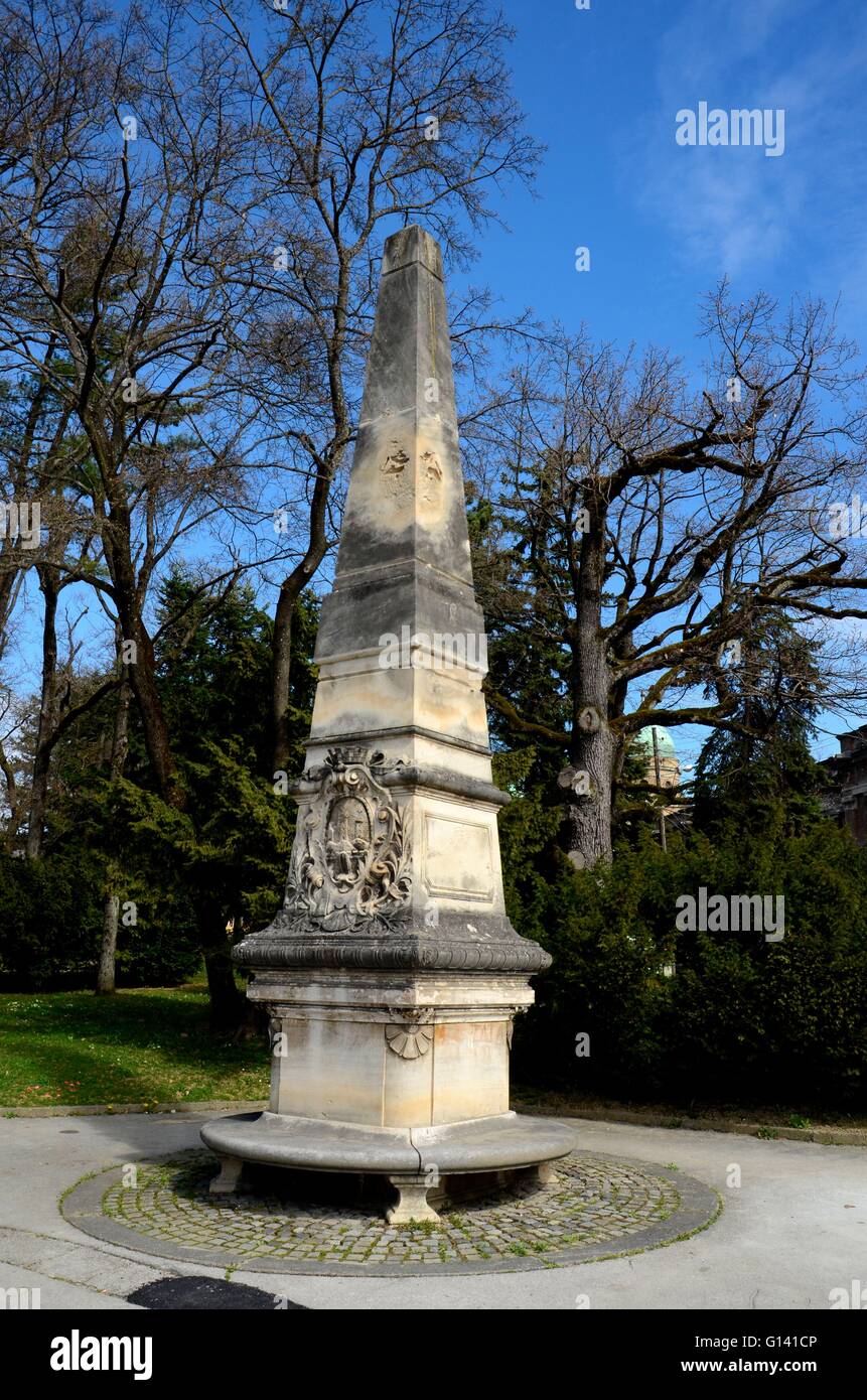 Memorial weathered obelisk on circular base at Mirogoj Cemetery Park ...