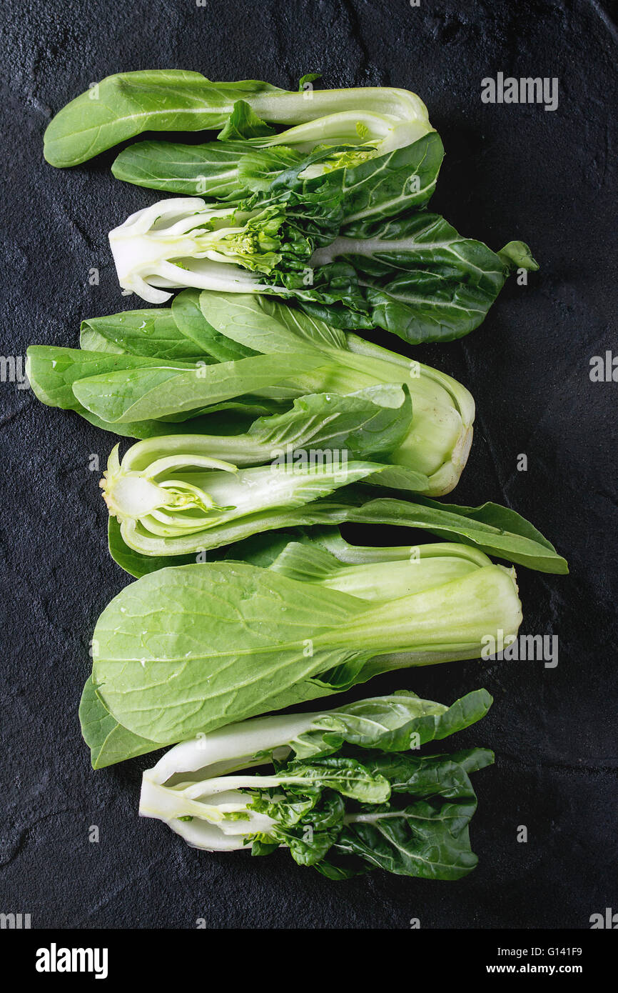 Assortment of whole and sliced raw baby bok choy (Chinese cabbage) over ...