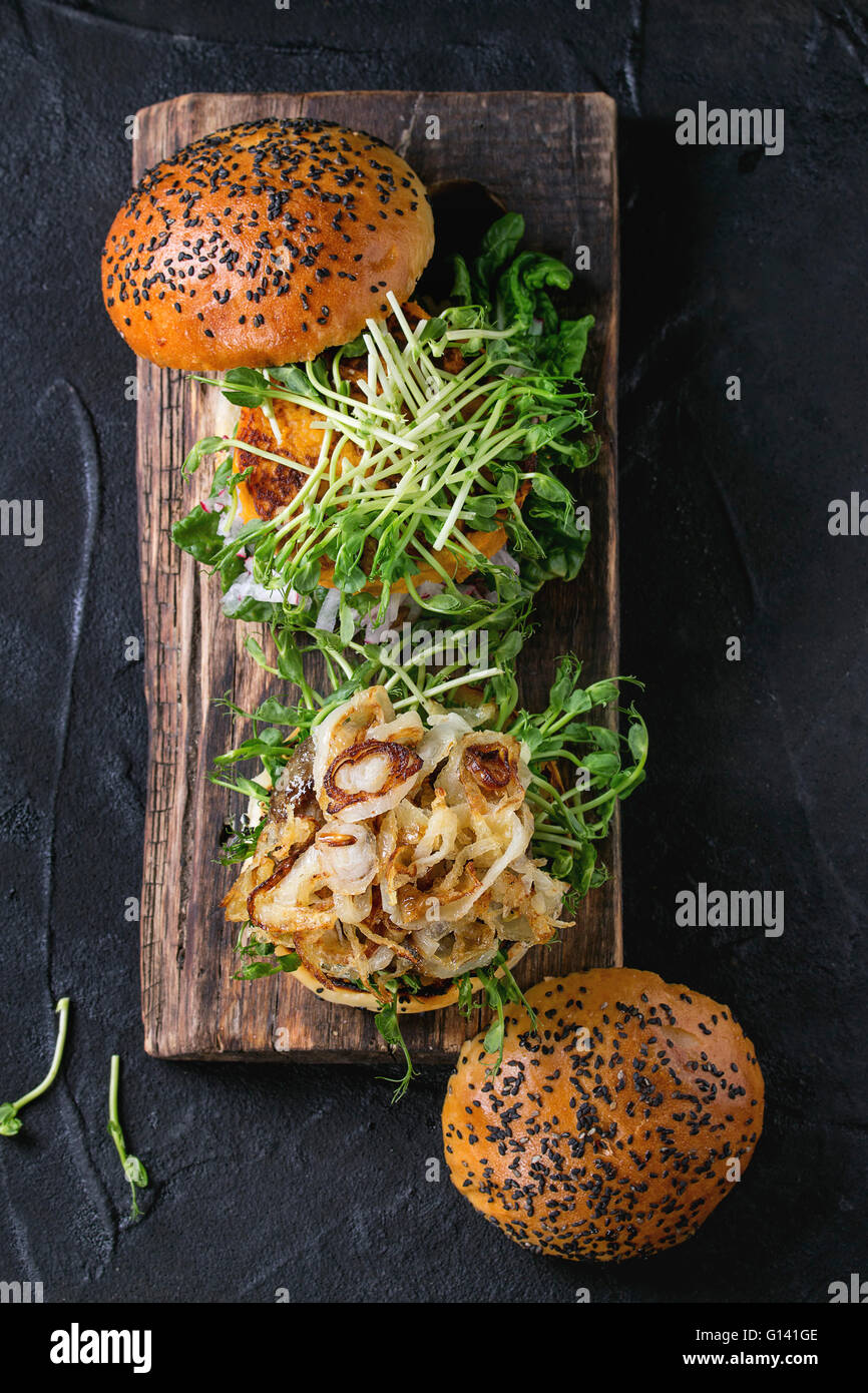Homemade traditional and veggie burgers with beef, fried onion, sweet ...