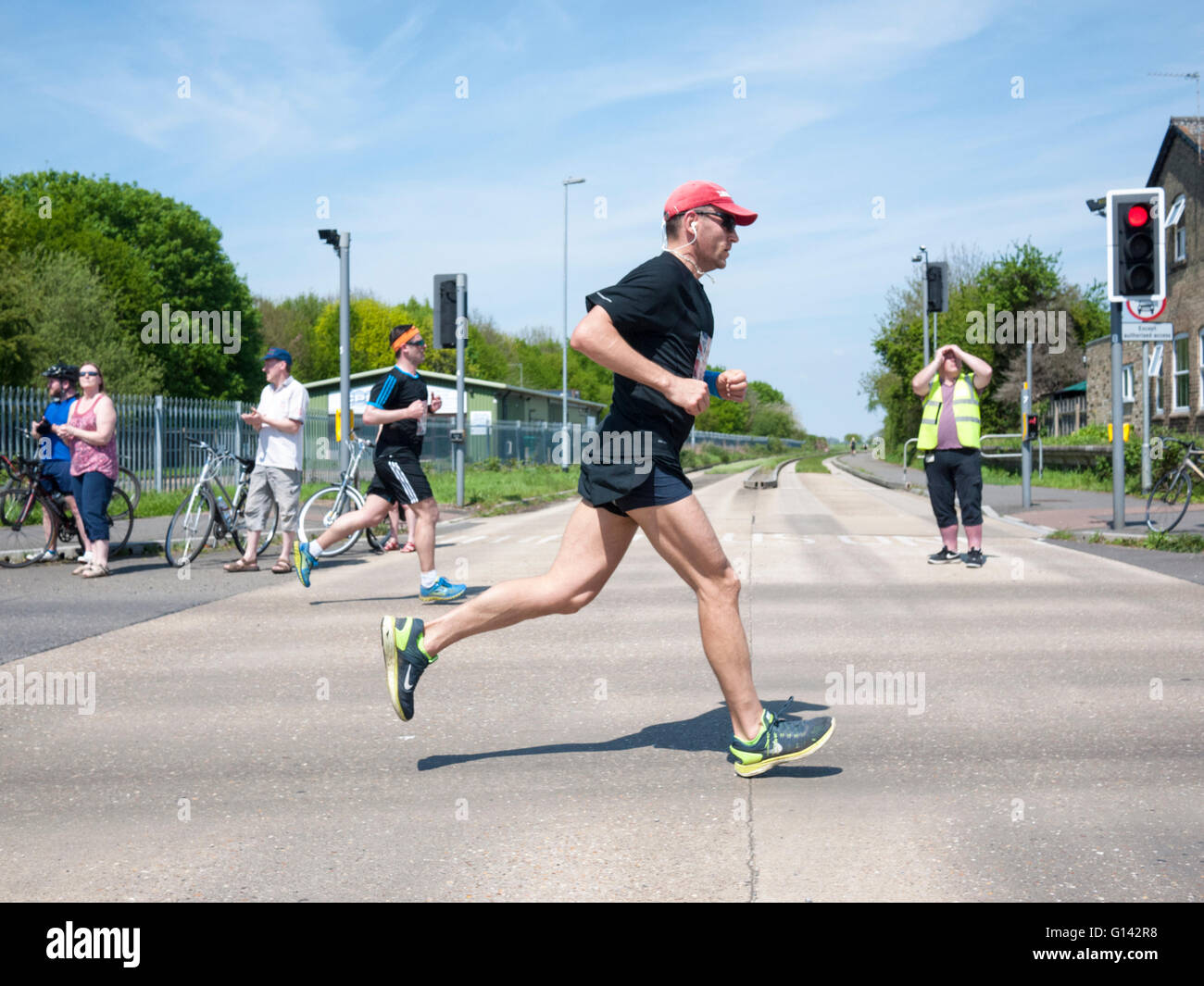 Runners pass finish line hi-res stock photography and images - Alamy