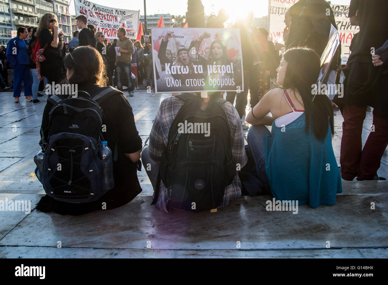 Athens, Greece. 08th May, 2016. Three women sit on the pavement outside ...