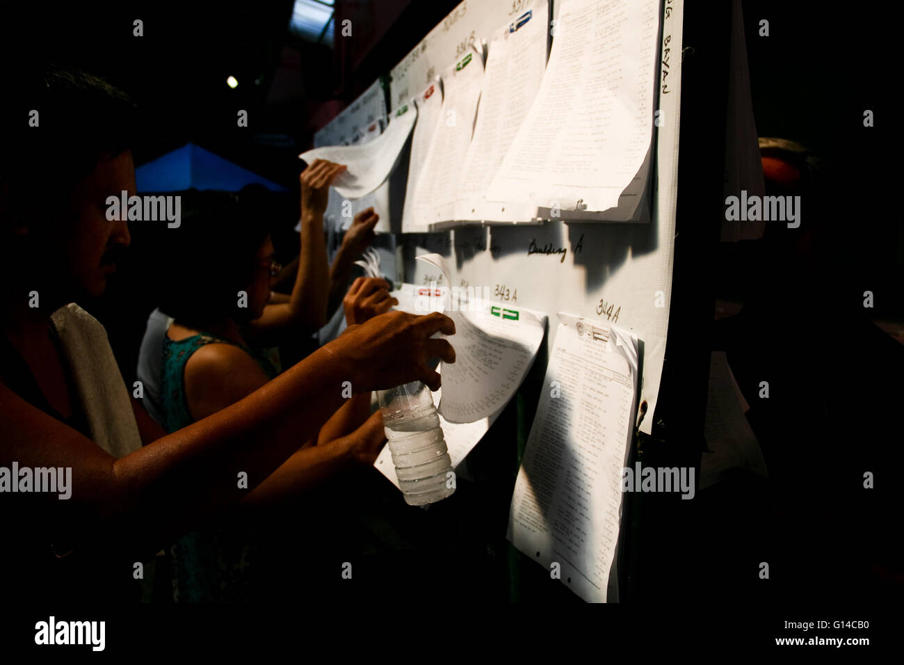 San Juan, Philippines. 09th May, 2016. A voter looks through pages of ...