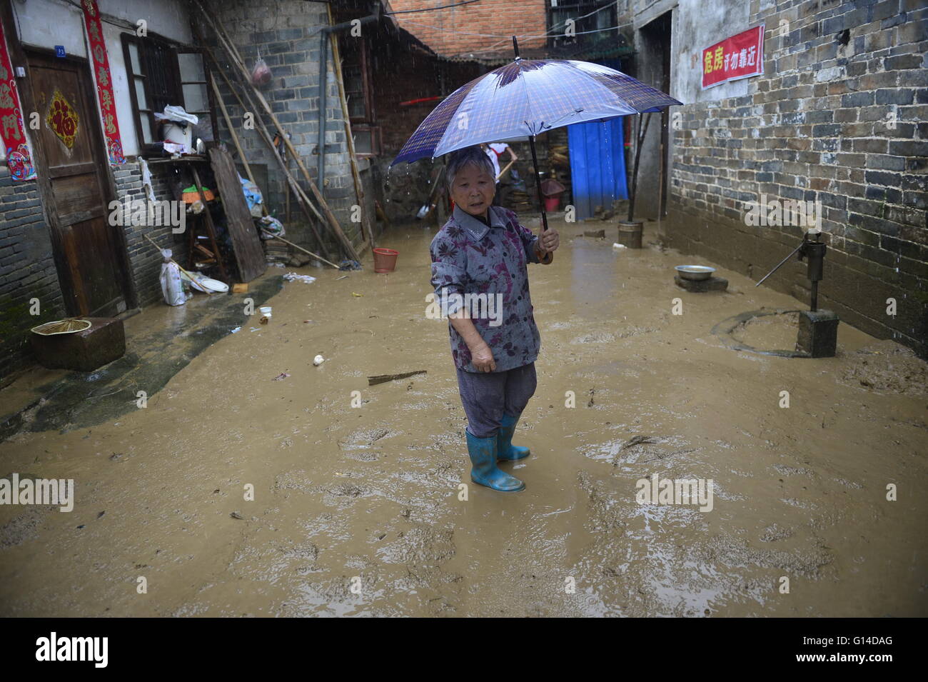 Lichuan, China's Jiangxi Province. 9th May, 2016. An old lady stands in ...