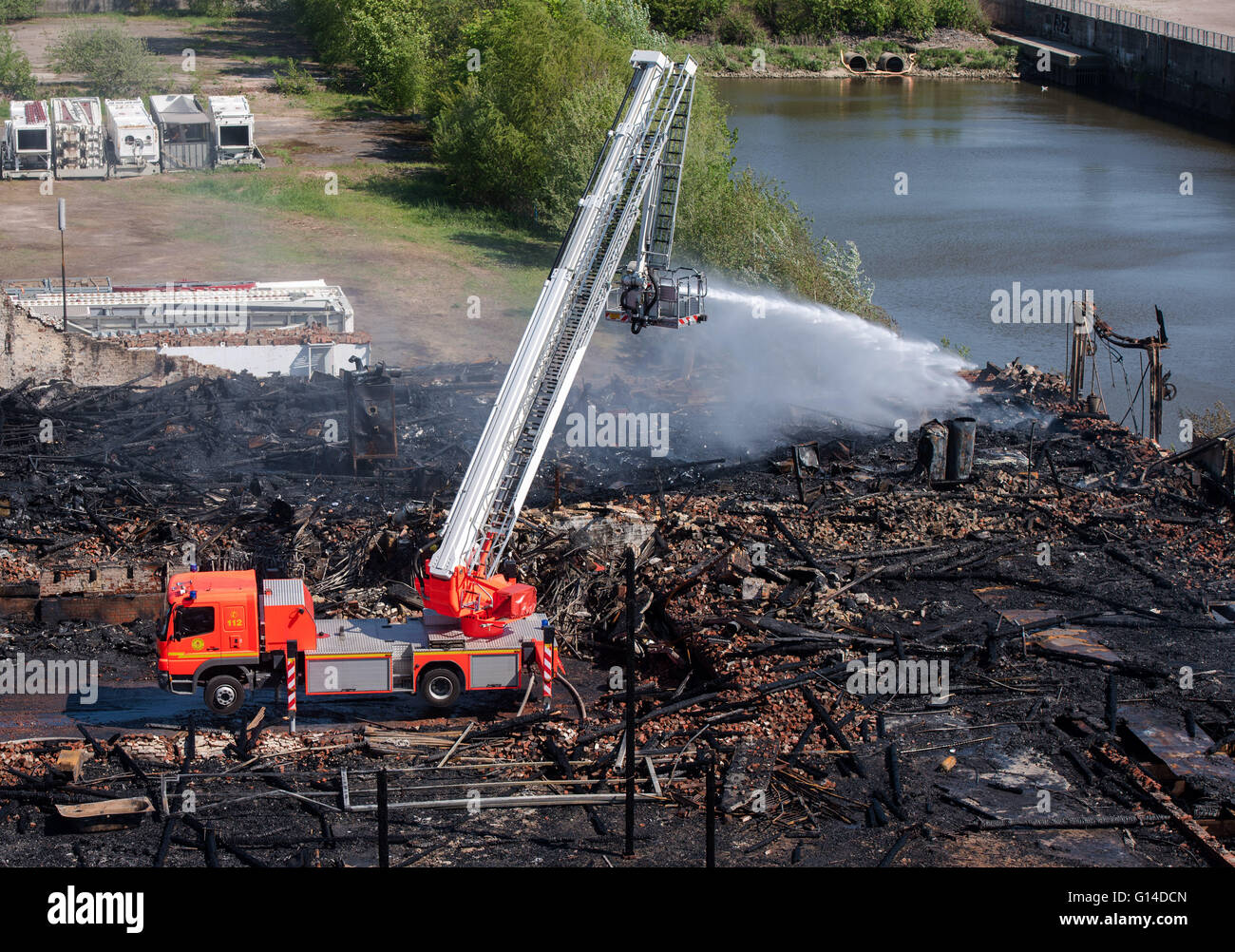 Hamburg, Germany. 09th May, 2016. A fire truck puts out the remains of ...