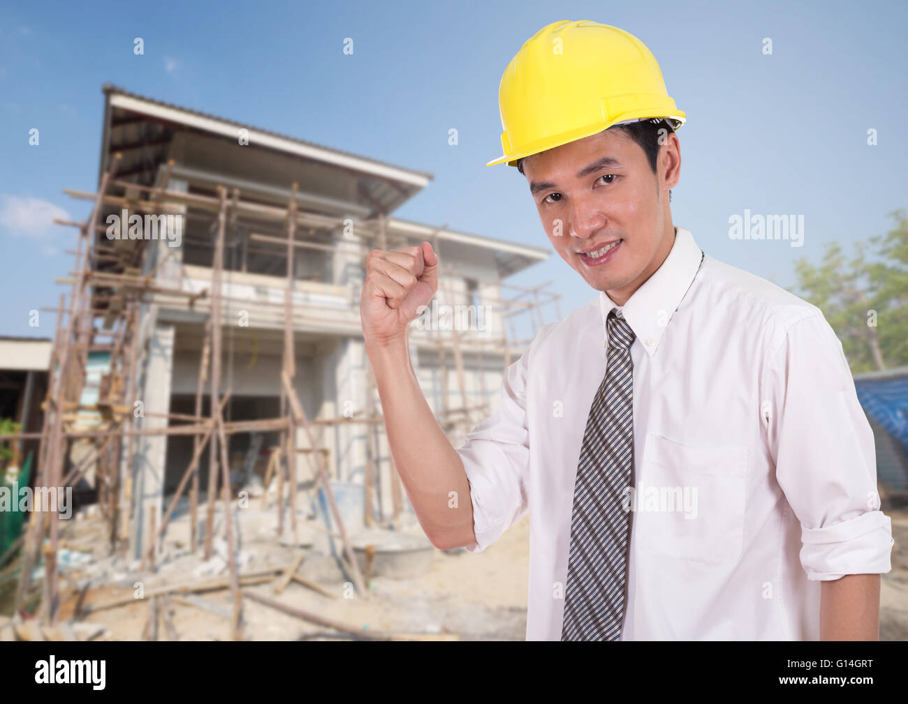 Happy engineer celebrating with arm raised, concept of successful ...