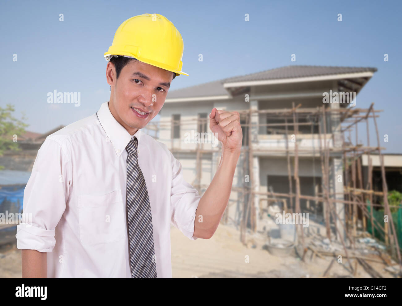 Happy engineer celebrating with arm raised, concept of successful ...