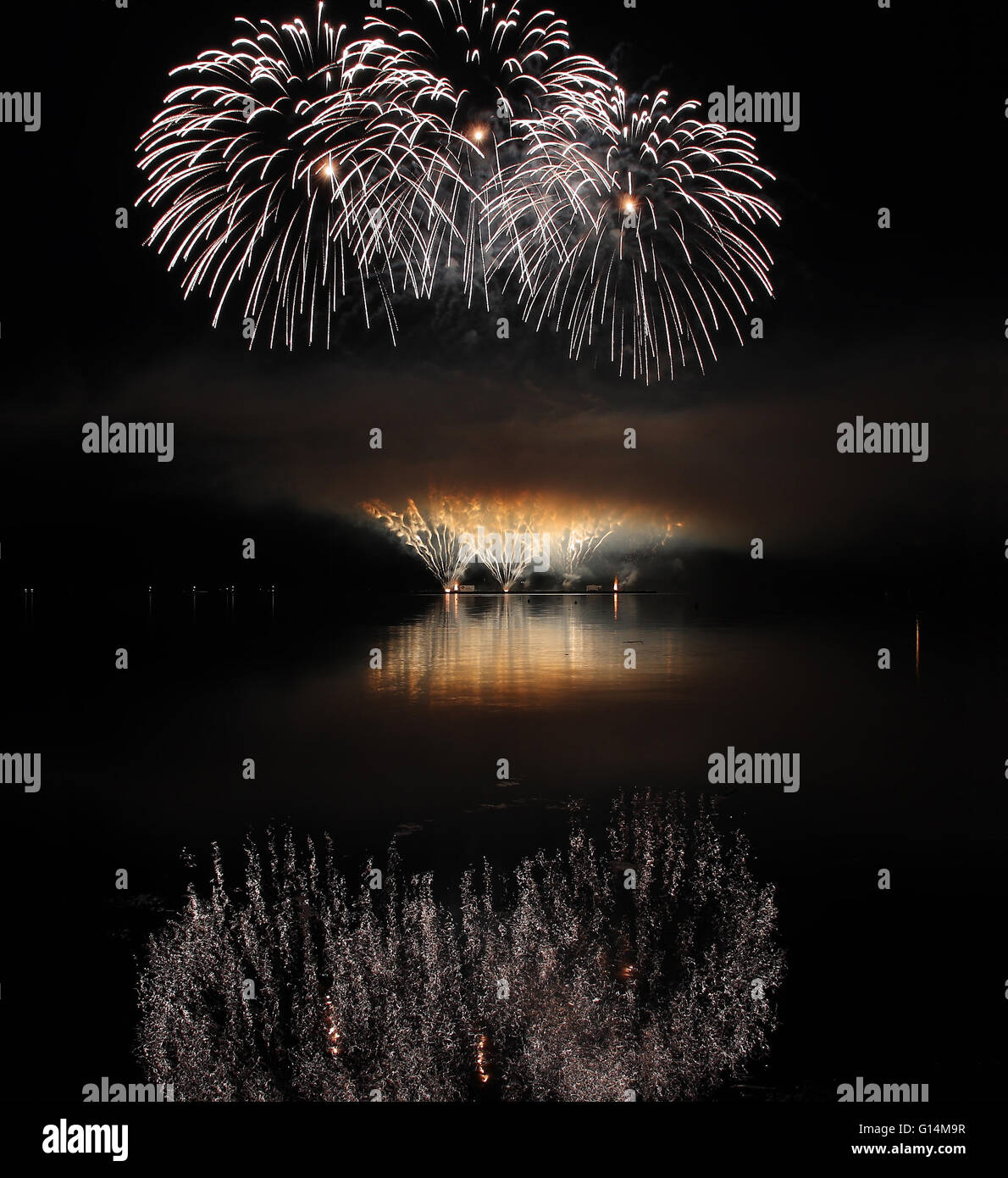 Colorful fireworks with reflection on lake and night sky in background ...