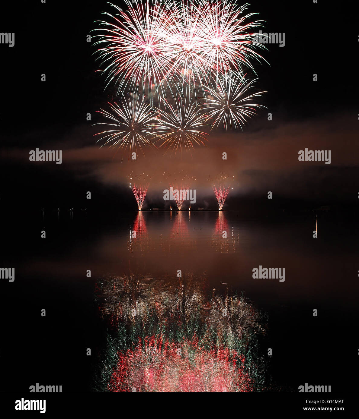 Colorful fireworks with reflection on lake and night sky in background ...