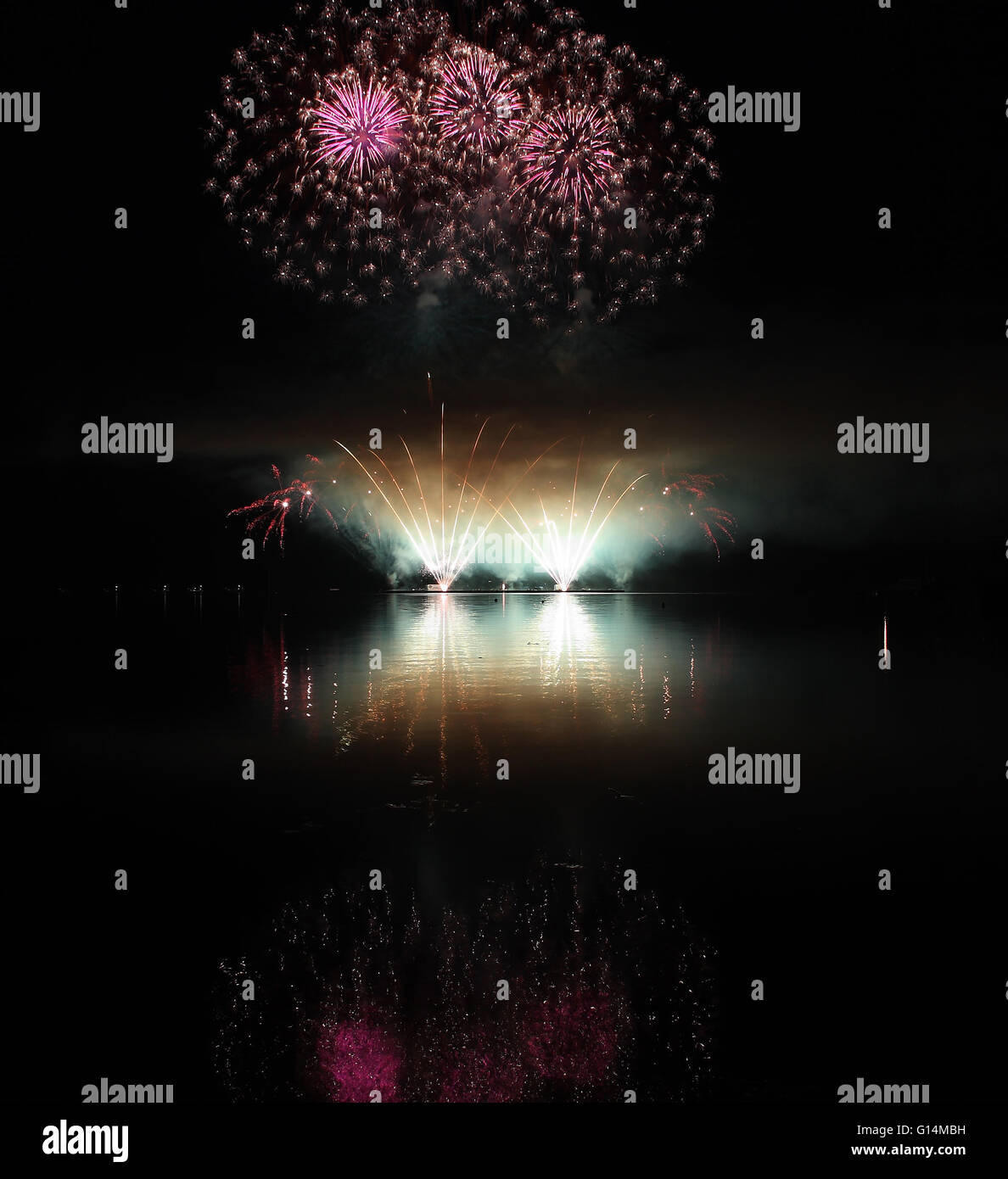 Colorful fireworks with reflection on lake and night sky in background ...