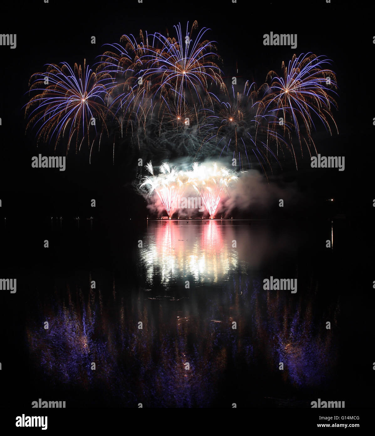 Colorful fireworks with reflection on lake and night sky in background ...